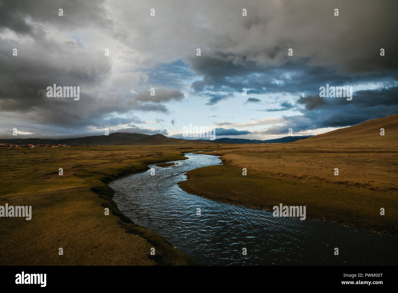 Mongolian landscape with river flowing into the distance on a cloudy ...