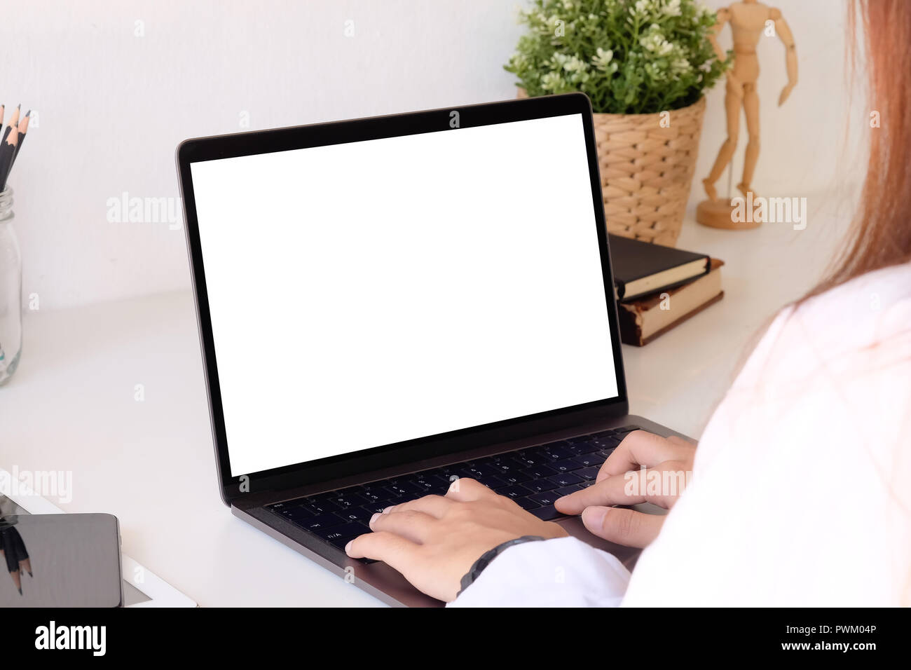 Female using mockup laptop computer on office desk Stock Photo - Alamy