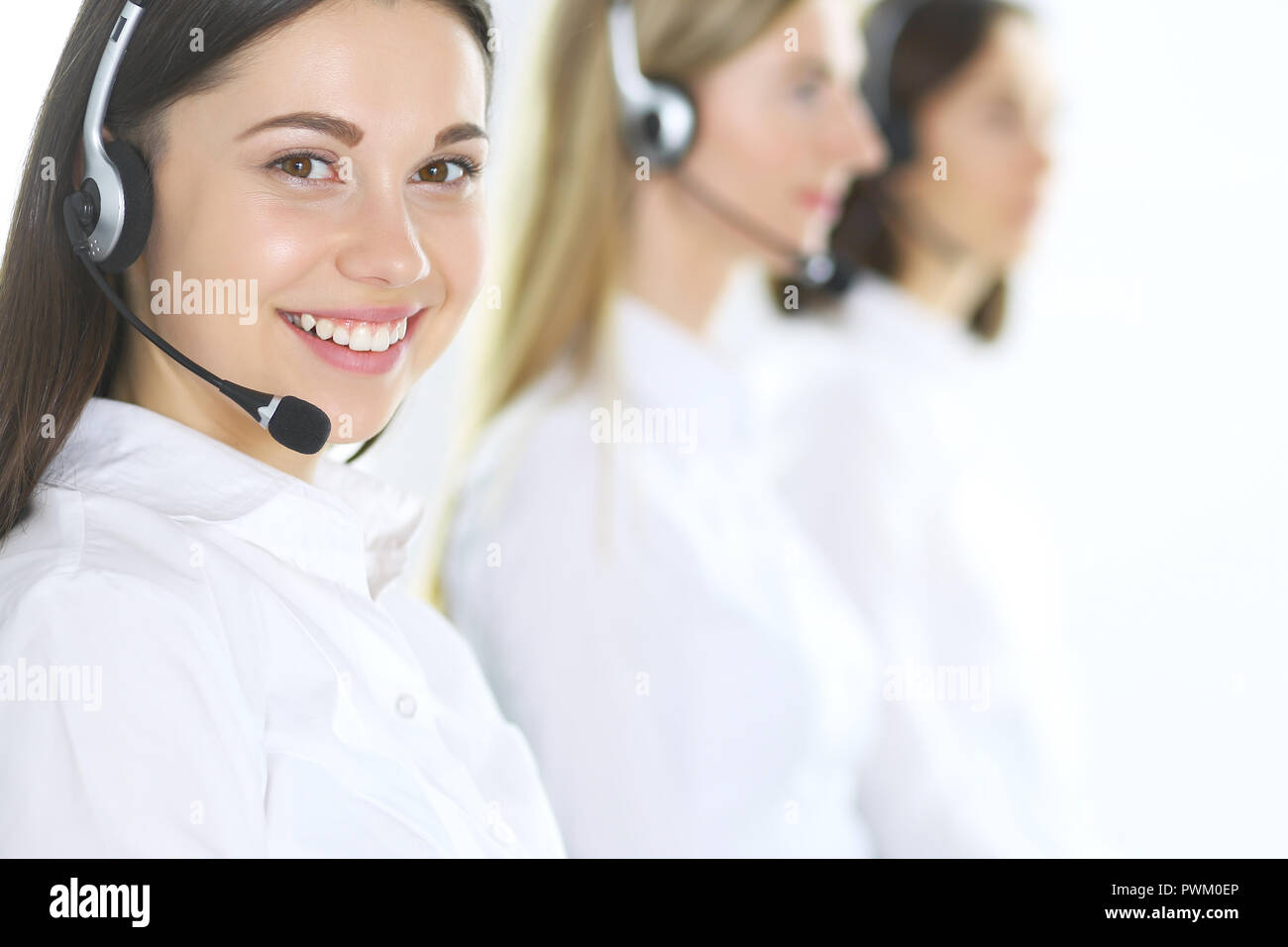Group of call center operators at work. Focus at beautiful business ...