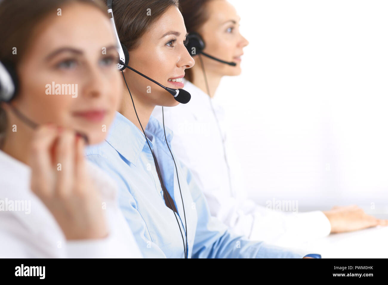 Call center. Group of operators at work. Focus on beautiful business woman in headset Stock ...