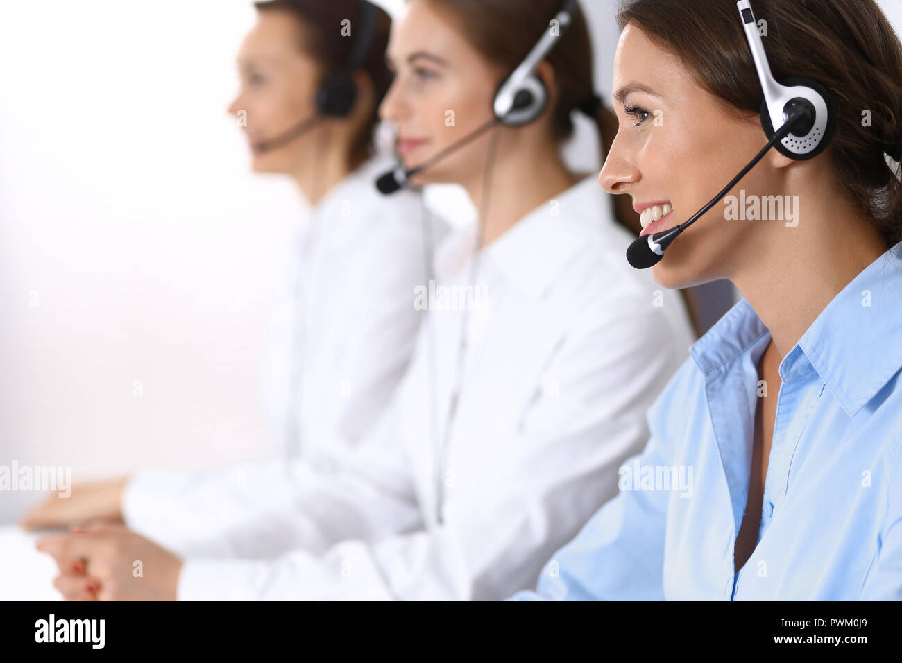 Call center. Group of operators at work. Focus on beautiful business ...