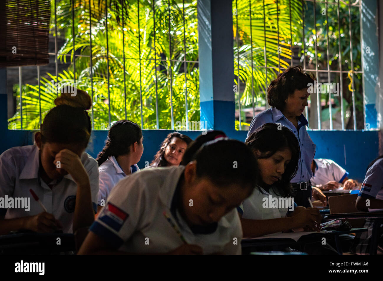 teacher helping students in guatemalan college Stock Photo - Alamy