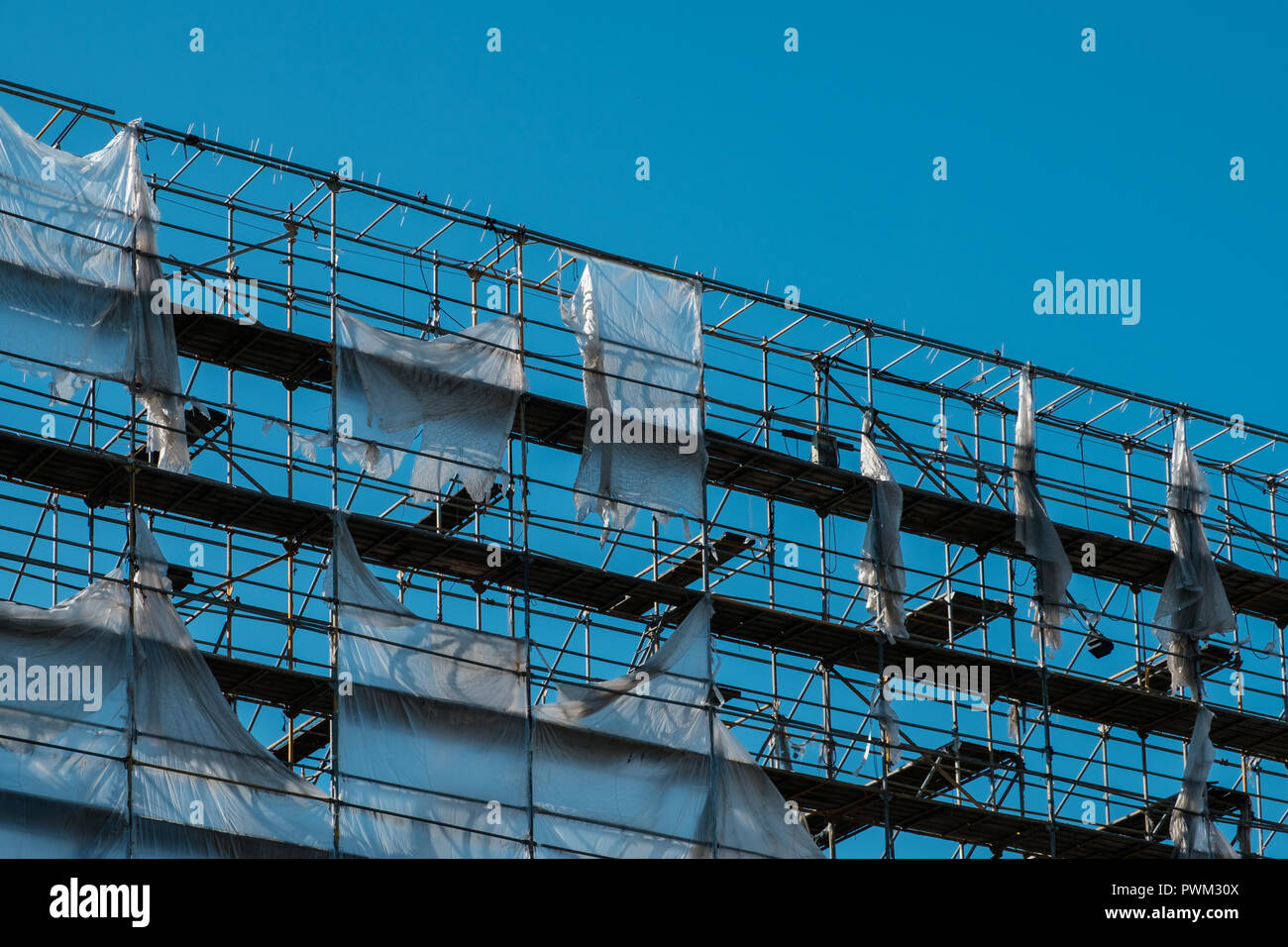scaffolding on blue sky background - construction frame Stock Photo - Alamy