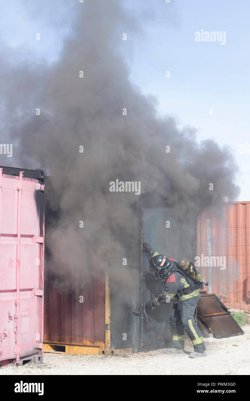 Firefighter putting out fire training station extinguisher backdraft ...