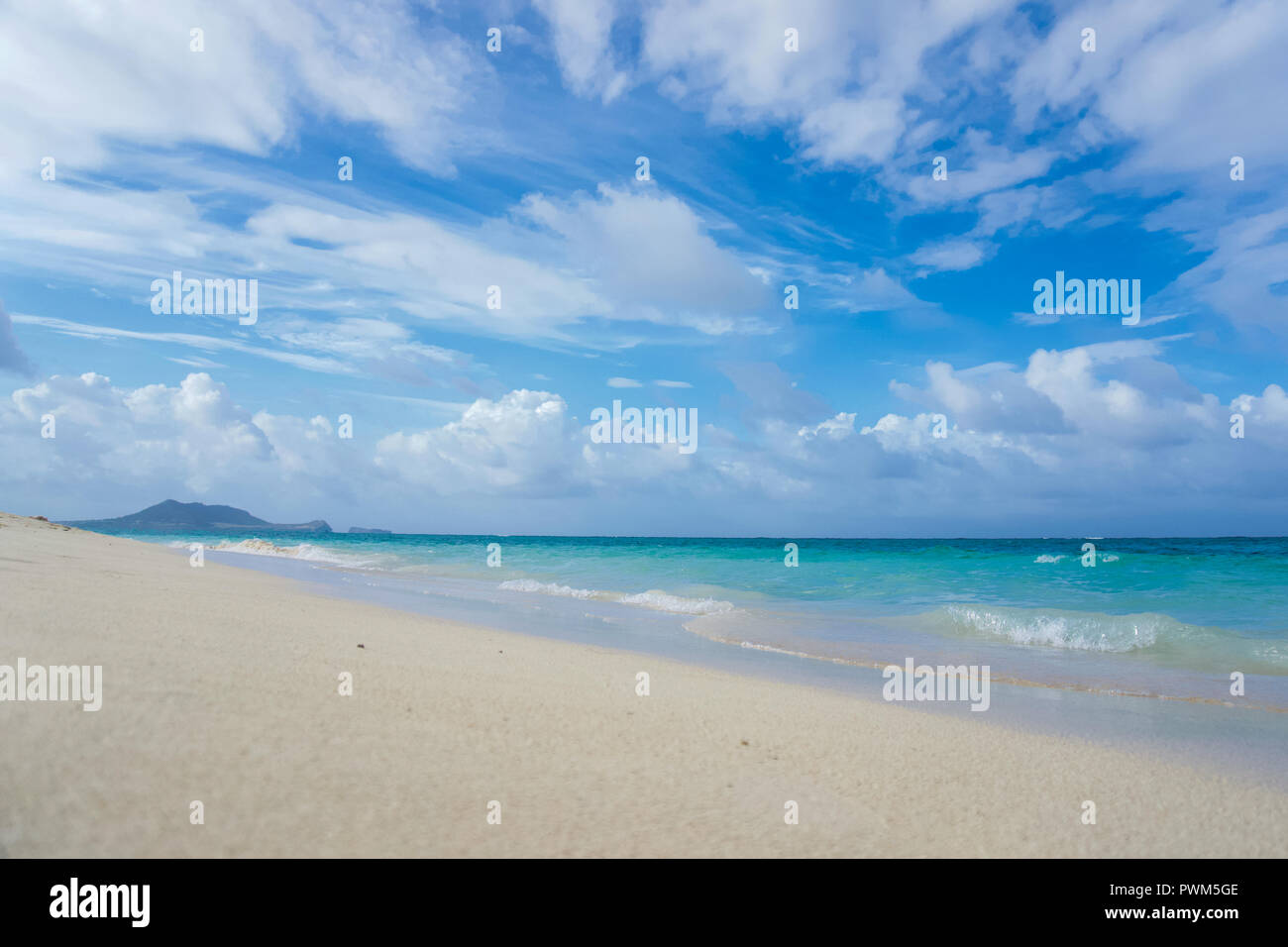 Low angle shot of serene beach in Hawaii with gentle waves of the ...