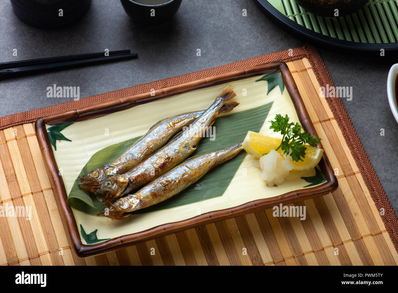 grilled shishamo served with lemon Stock Photo - Alamy