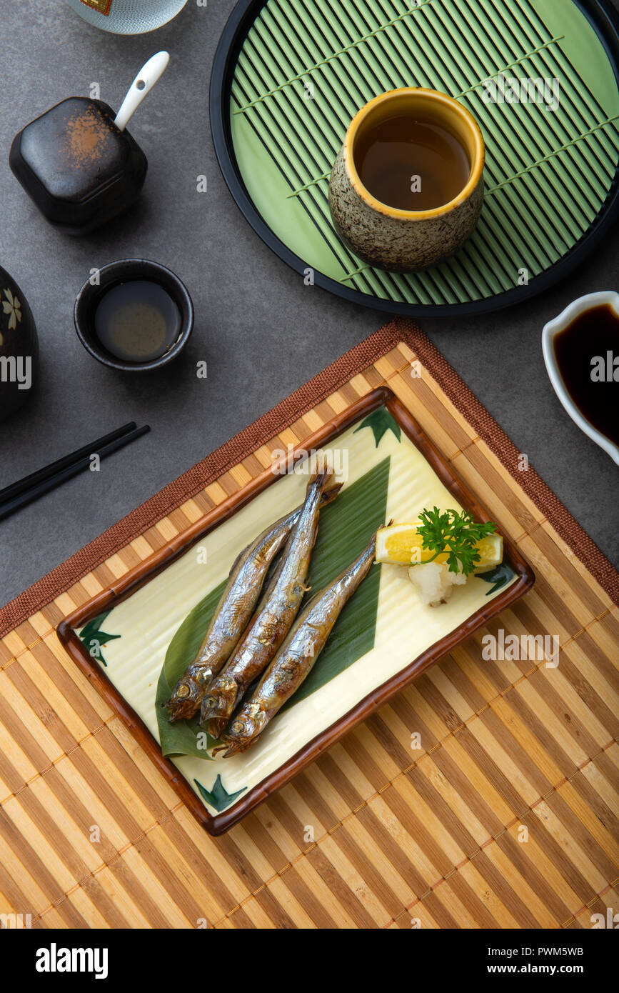 grilled shishamo served with lemon Stock Photo - Alamy