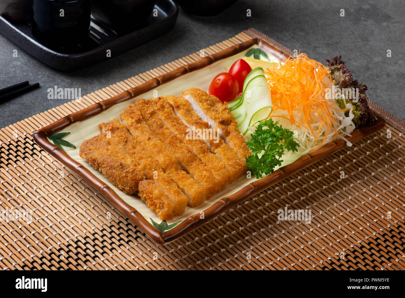 Japanese deep fried pork or tonkatsu set with rice in studio lighting ...