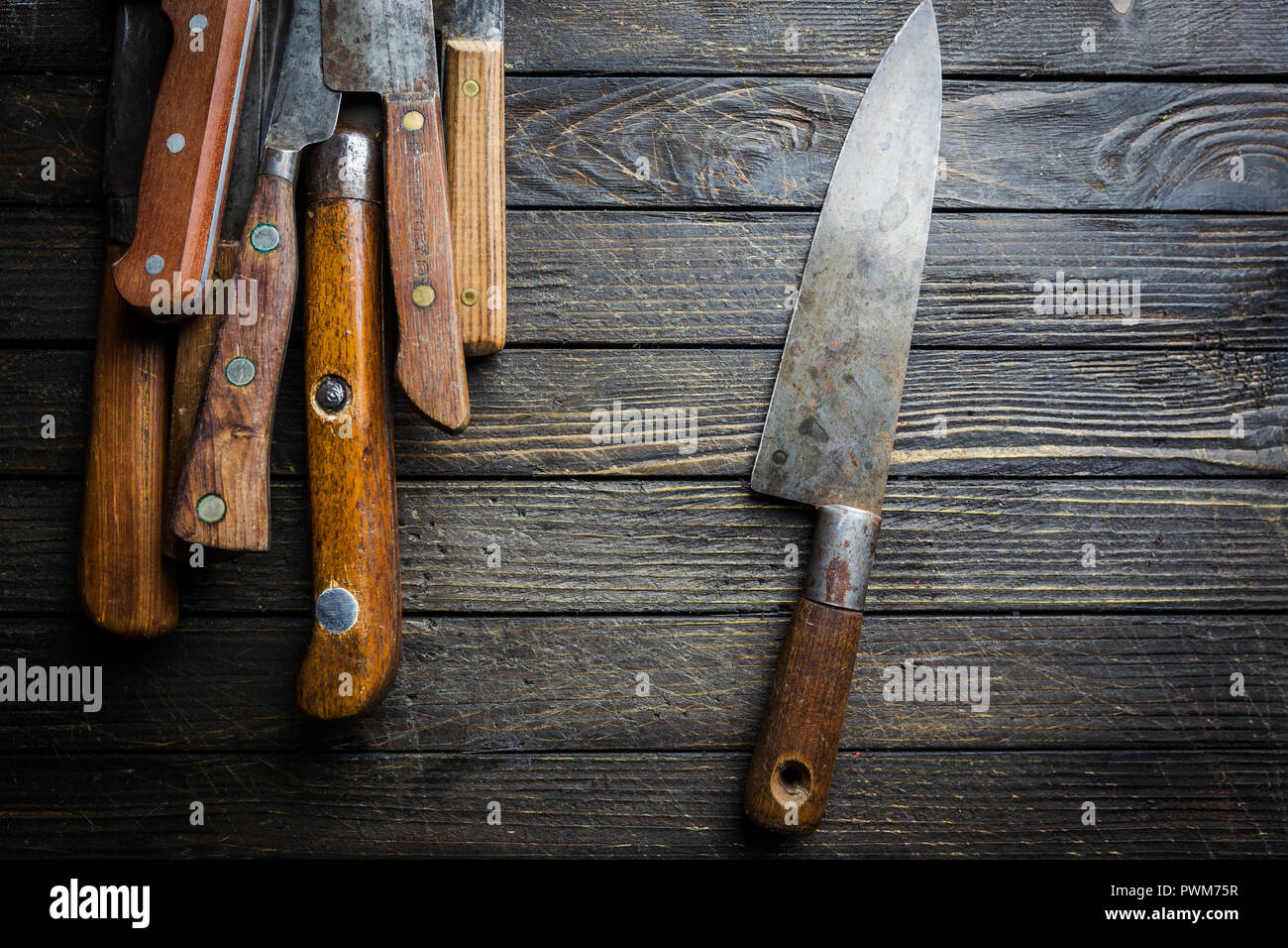 Set of Vintage kitchen knives and meat cleaver on dark wood background ...