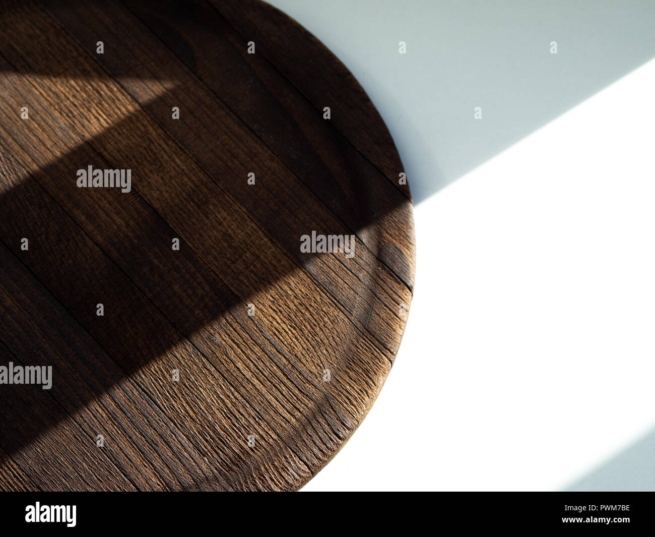 lines of sunlight and shadows on the surface; wooden texture and white ...