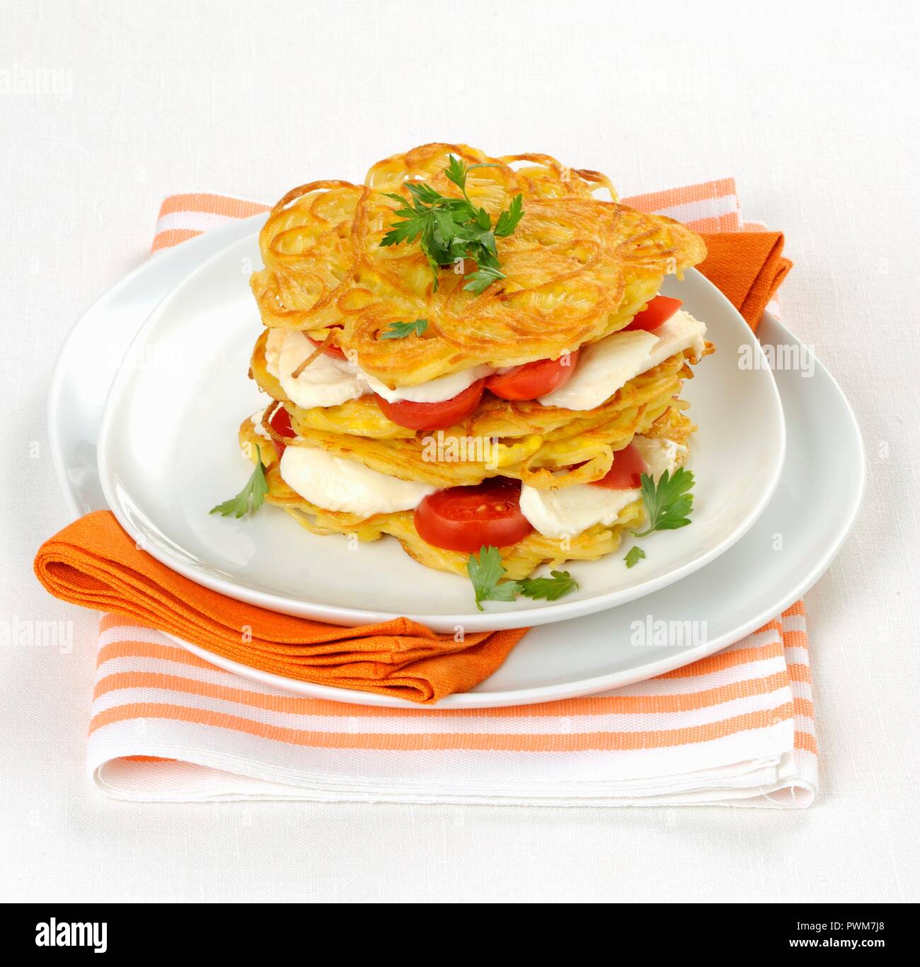 Crispy spaghetti fritters with mozzerella and tomatoes Stock Photo - Alamy