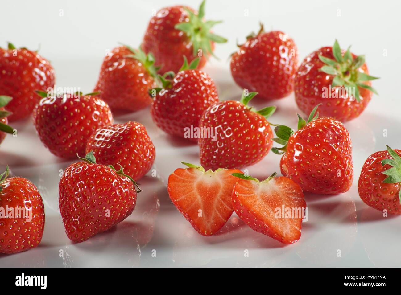 Fresh strawberries, whole and halved Stock Photo - Alamy