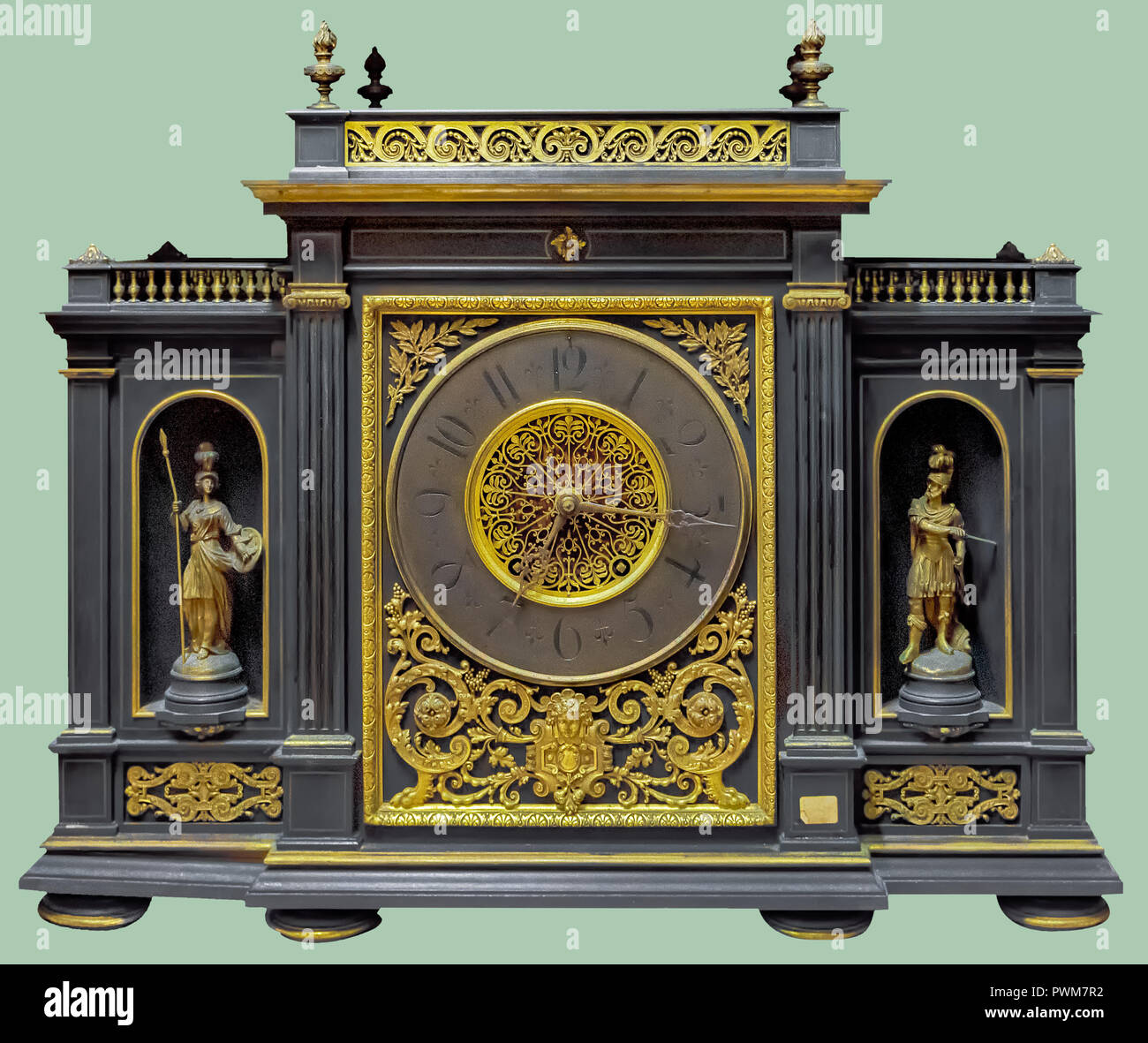 Mantel clock with brass figurines housed in a wooden case carved in ...