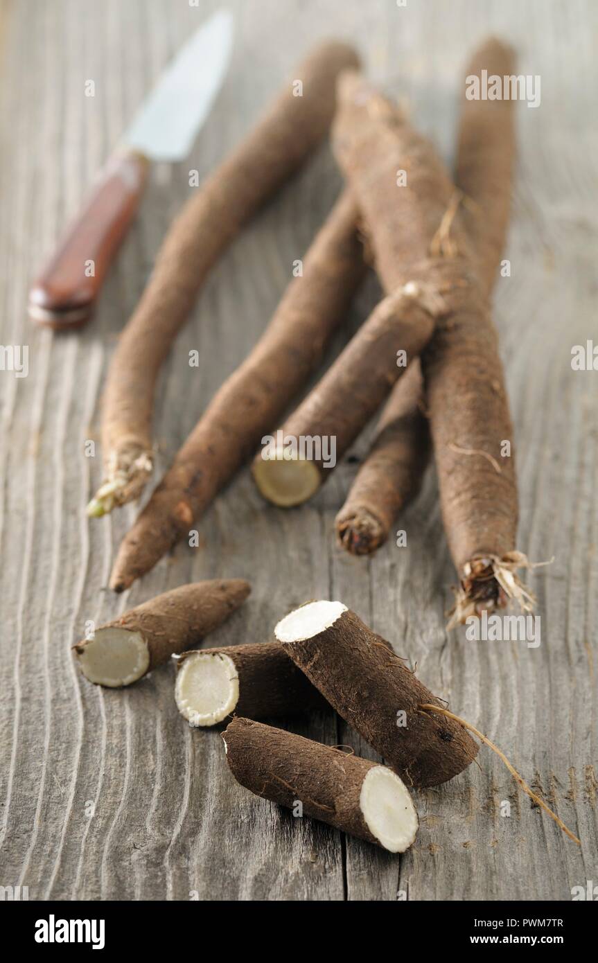 Black salsify, partially sliced, on a wooden surface Stock Photo - Alamy