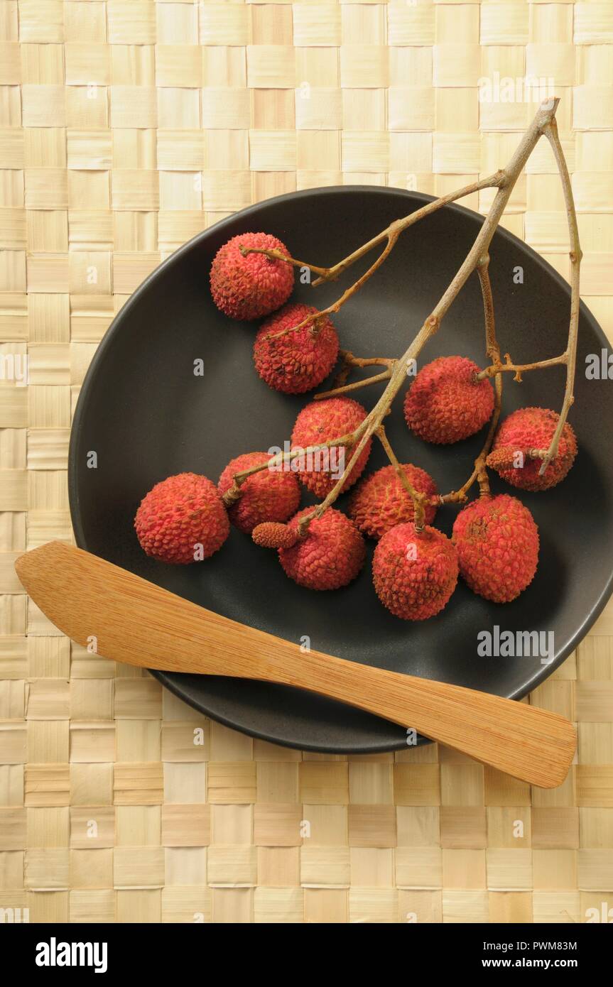 Lychees on a sprig on a plate Stock Photo - Alamy