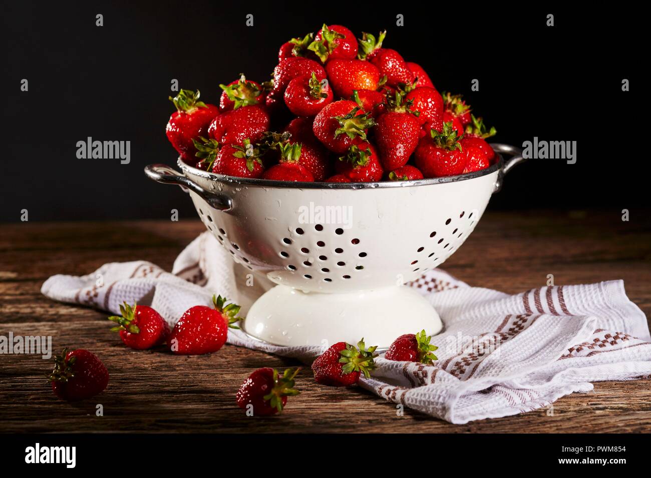 Strawberries in a colander Stock Photo - Alamy