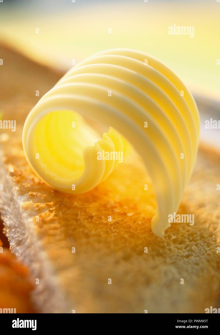Butter curl on toast (close-up Stock Photo - Alamy