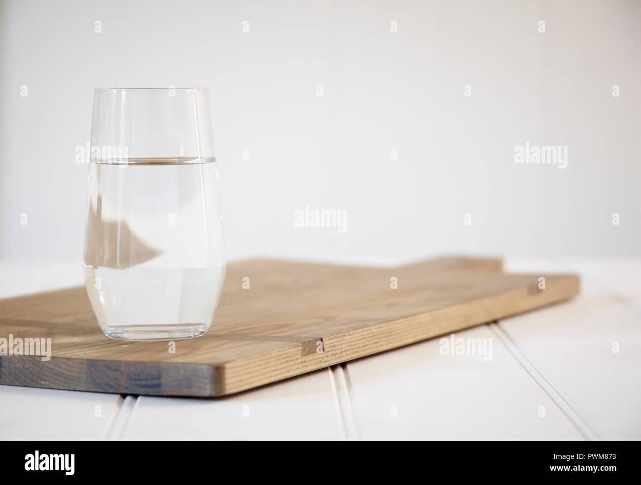 A glass of water on a chopping board Stock Photo - Alamy