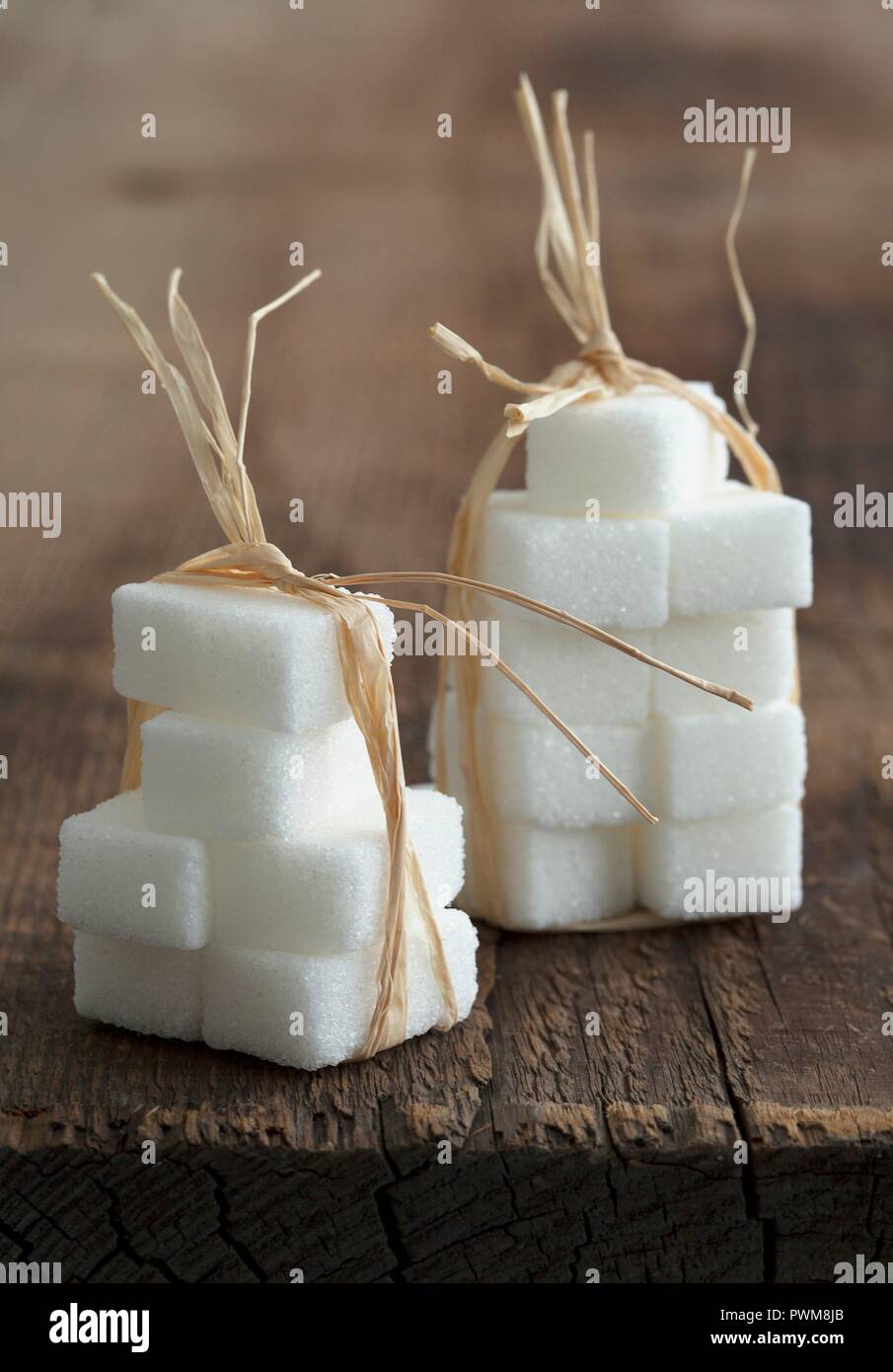 Sugar cubes tied together with raffia ribbon Stock Photo - Alamy
