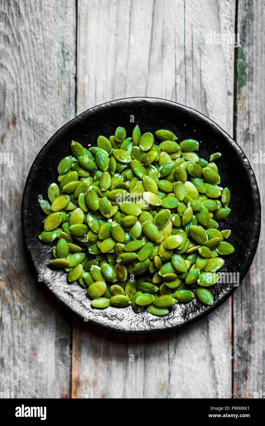 Pumpkin seeds in addition on a wooden surface Stock Photo - Alamy