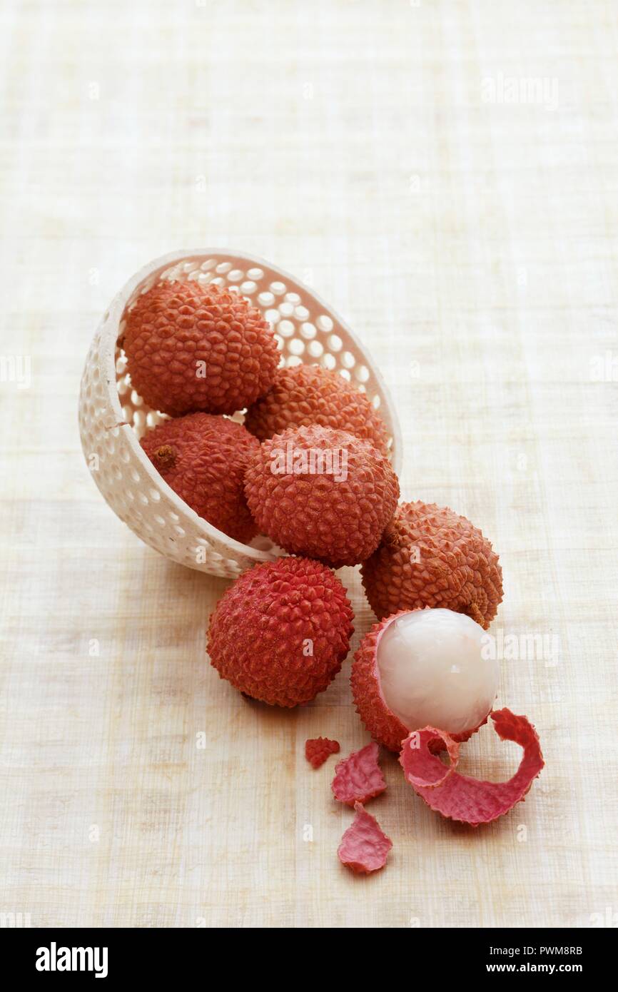 Lychees, one half peeled Stock Photo - Alamy