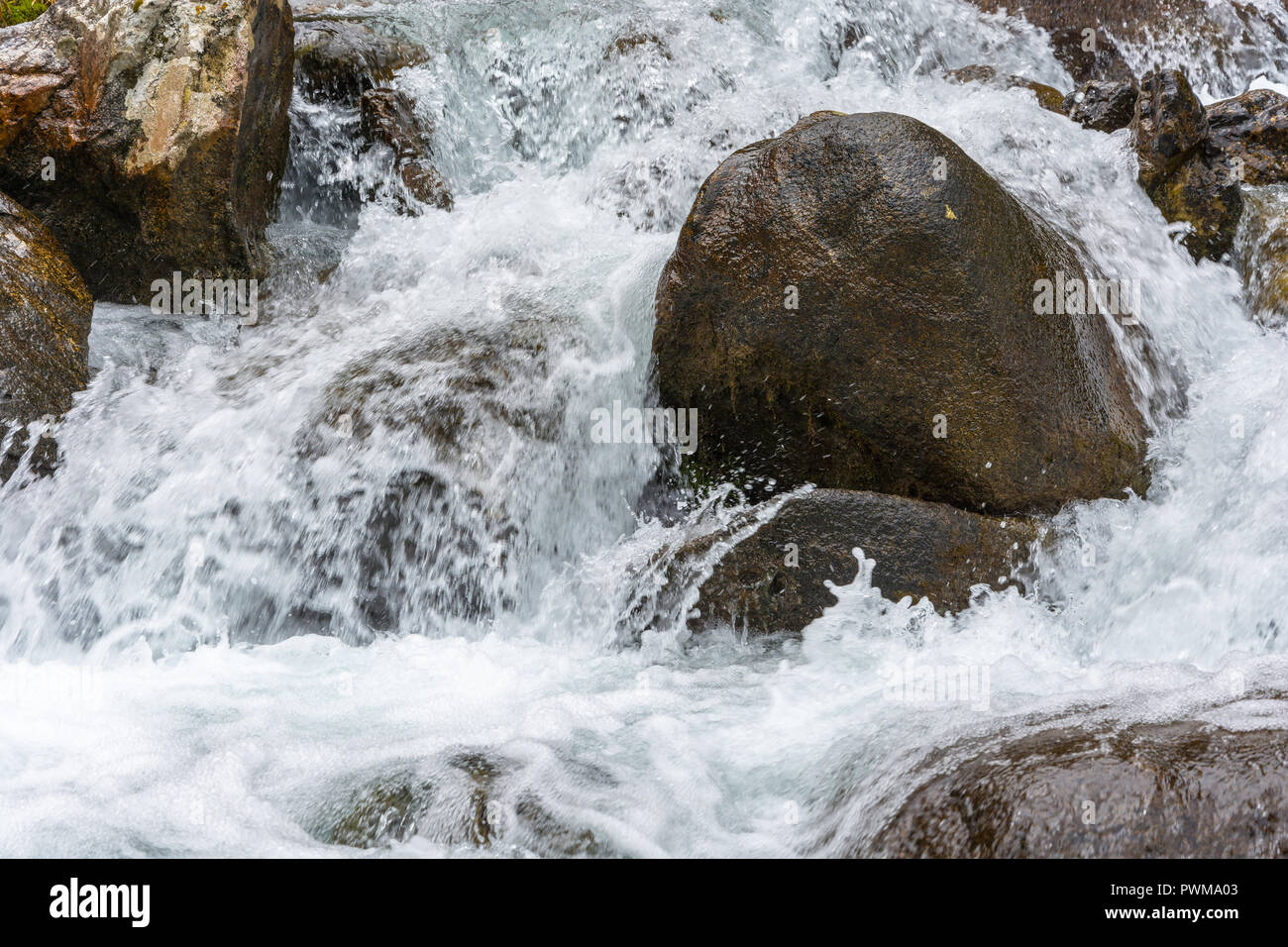 Huge wet rocks in a stream of bubbling mountain river Stock Photo - Alamy