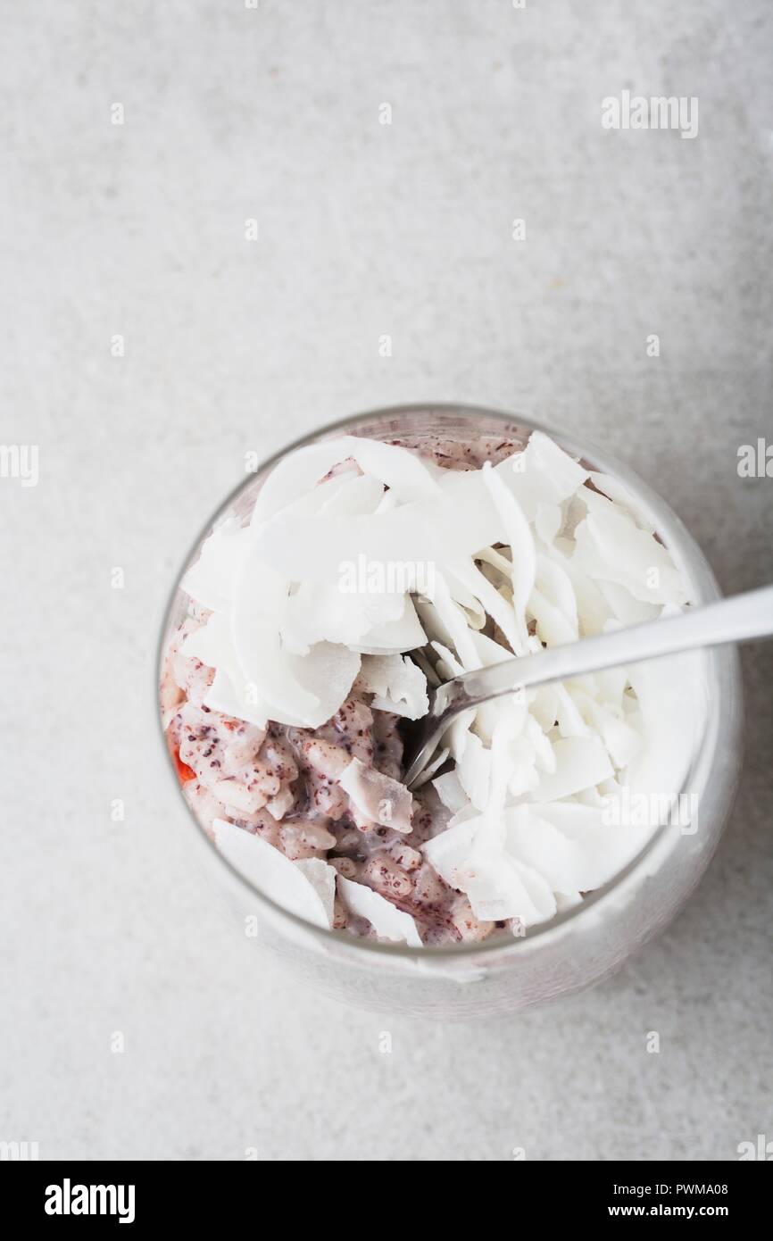 Rice pudding with cranberries and coconut in a glass (seen from above ...