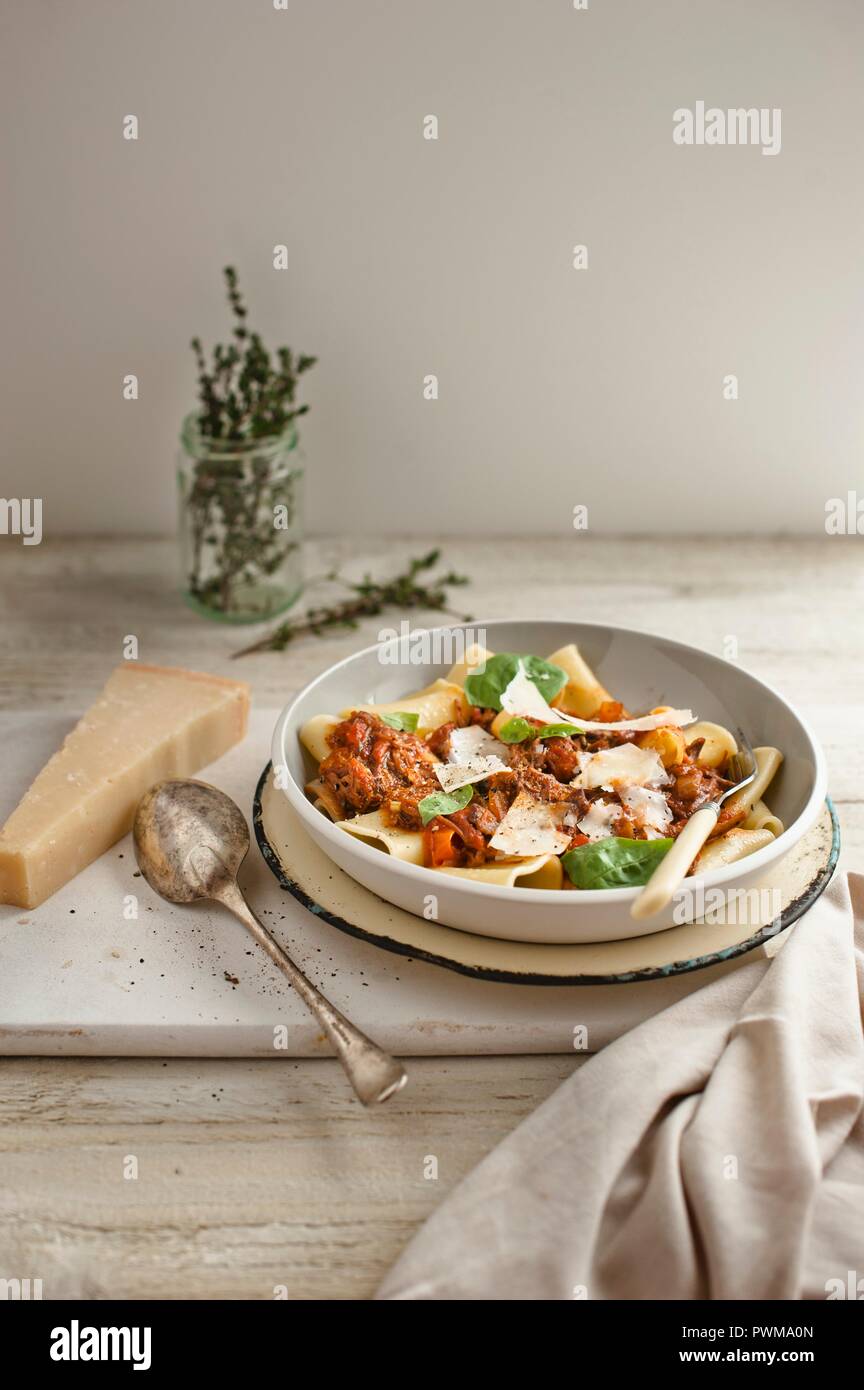 Pasta with beef ragout, Parmesan cheese and basil Stock Photo - Alamy