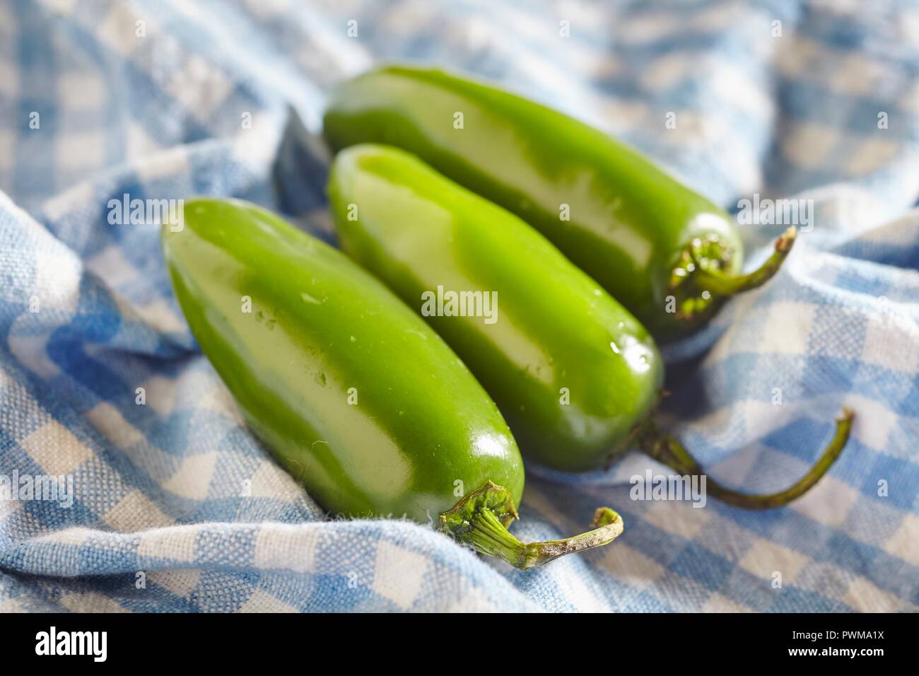 Three fresh, green jalapeños Stock Photo - Alamy