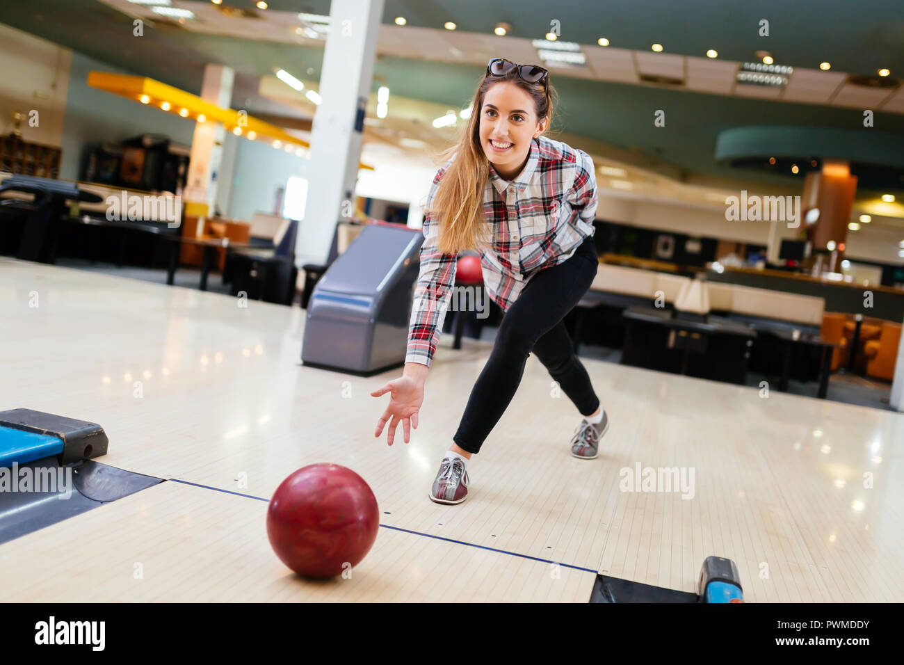 Cheerful friends bowling together and having fun Stock Photo - Alamy
