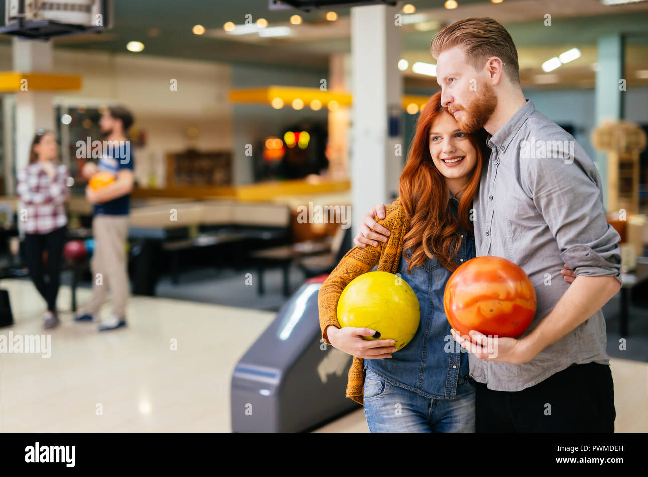 Cheerful friends bowling together and having fun Stock Photo - Alamy