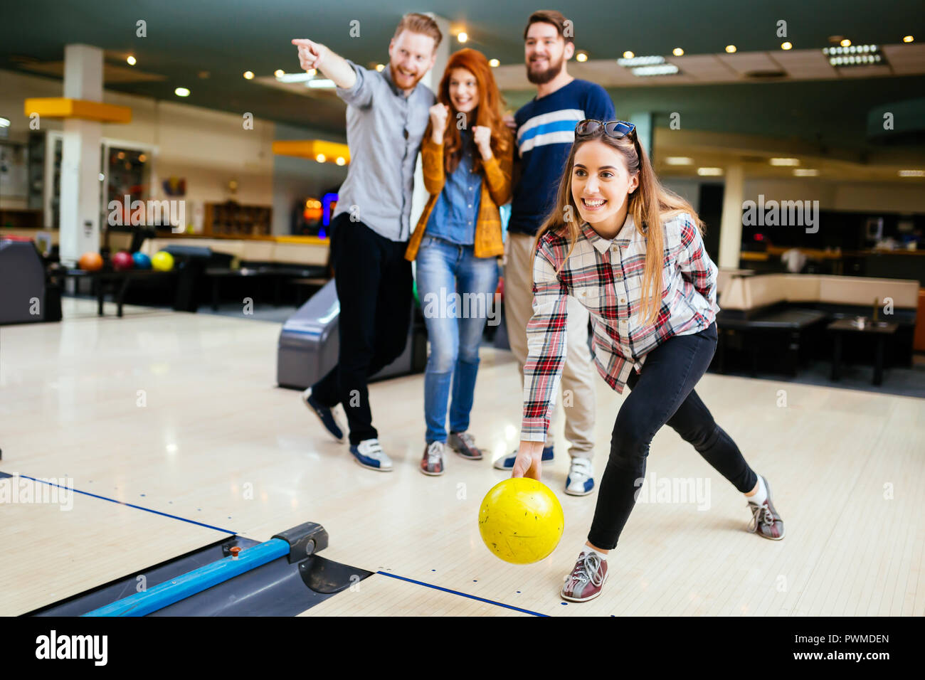 Competitve people enjoying bowling Stock Photo - Alamy