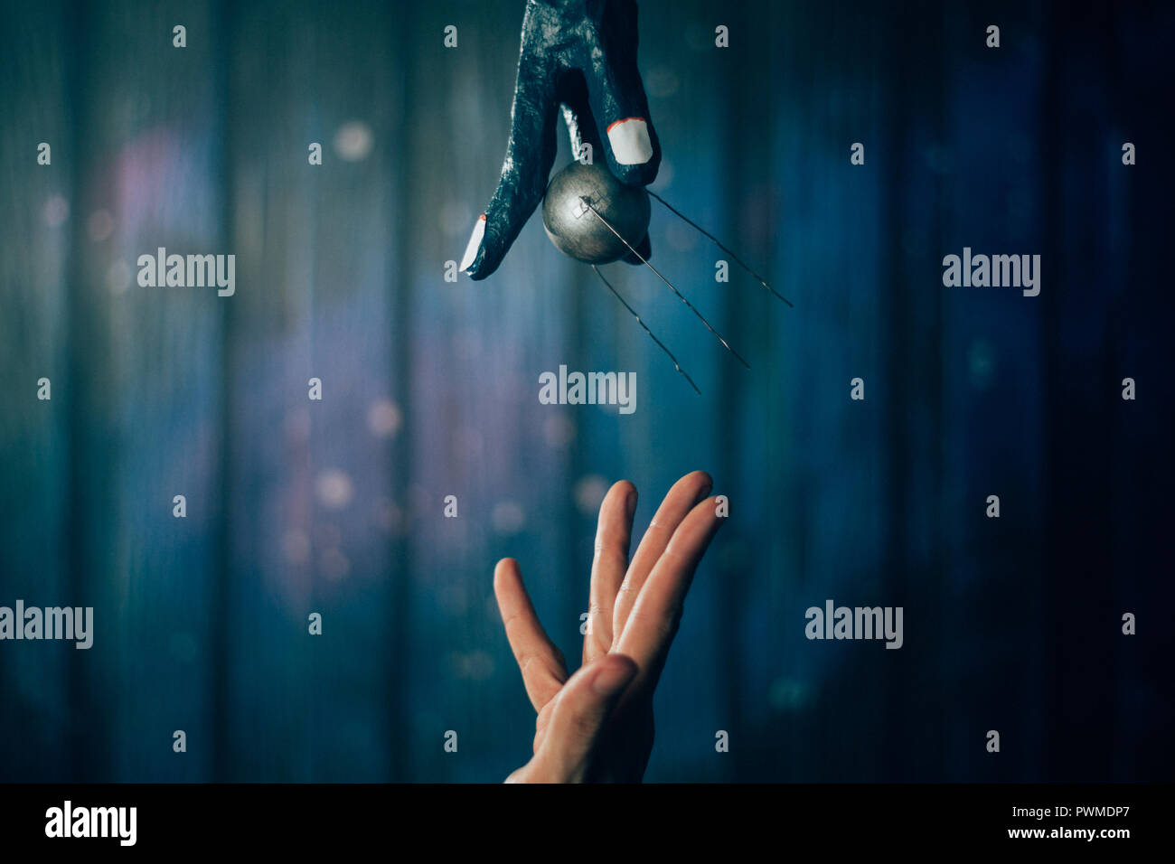 Hand reaching for a gift from the alien. A kid just got a tiny ...