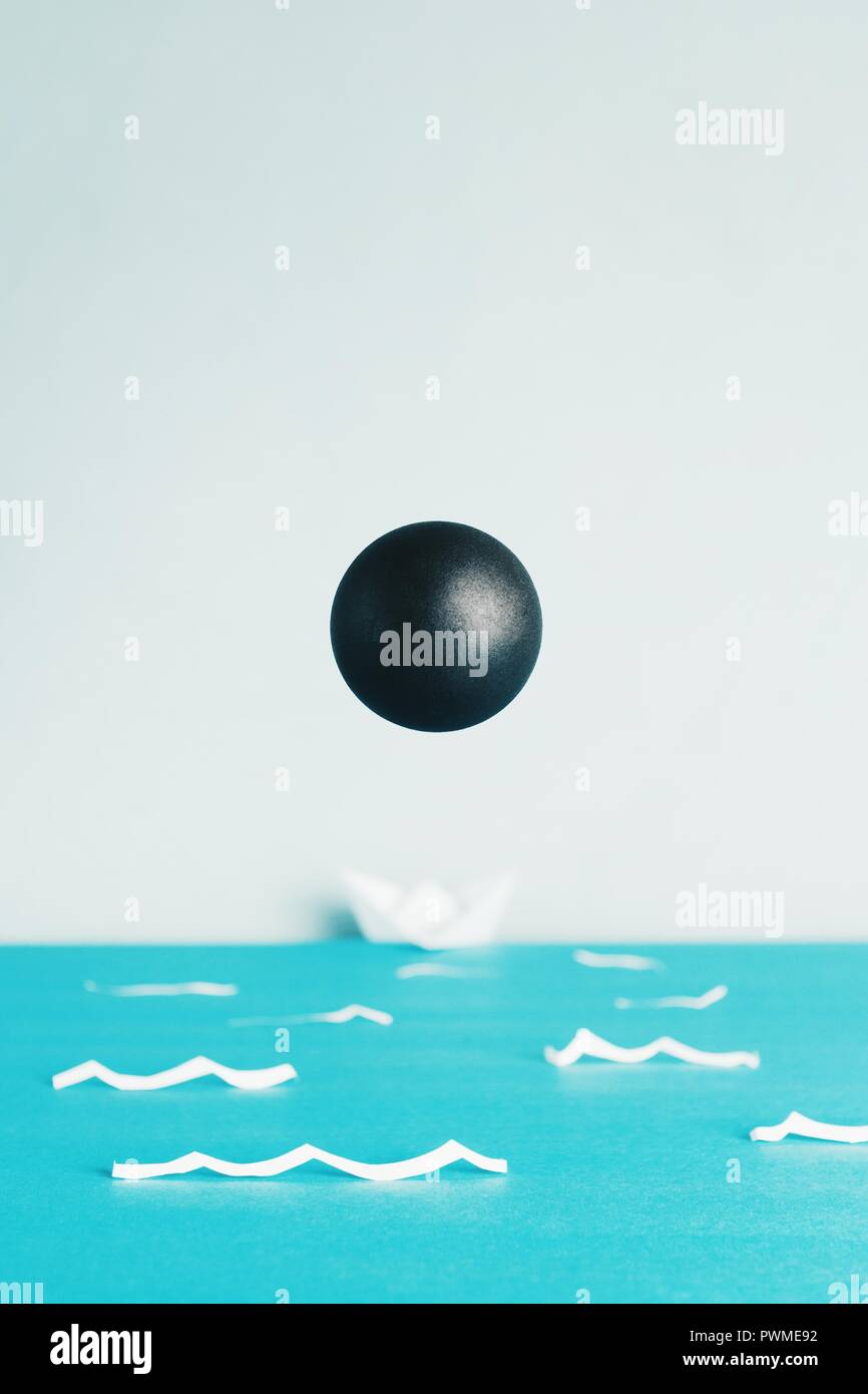 Cannon ball flying into a paper boat Stock Photo - Alamy