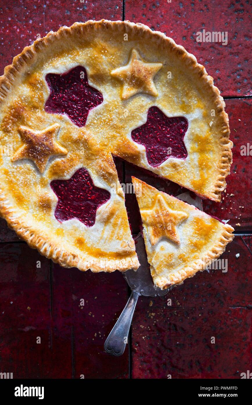 Raspberry pie with pastry stars, sliced Stock Photo - Alamy