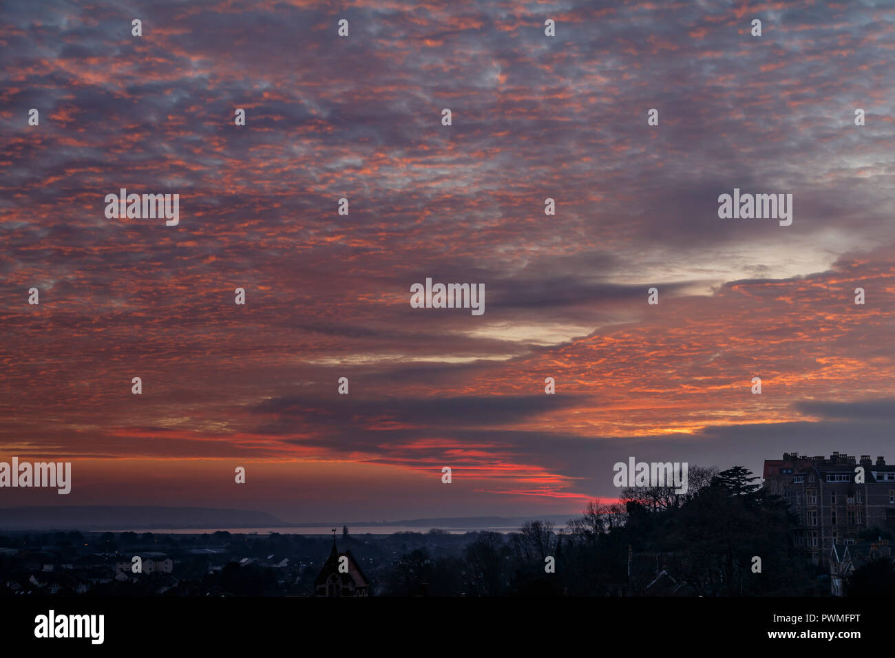 The setting sun lighting up the edge of the cloud-cover Stock Photo - Alamy