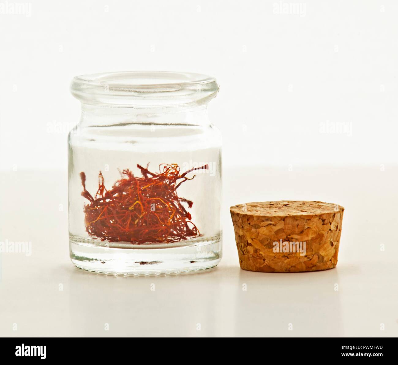 Saffron threads in a small bottle Stock Photo - Alamy