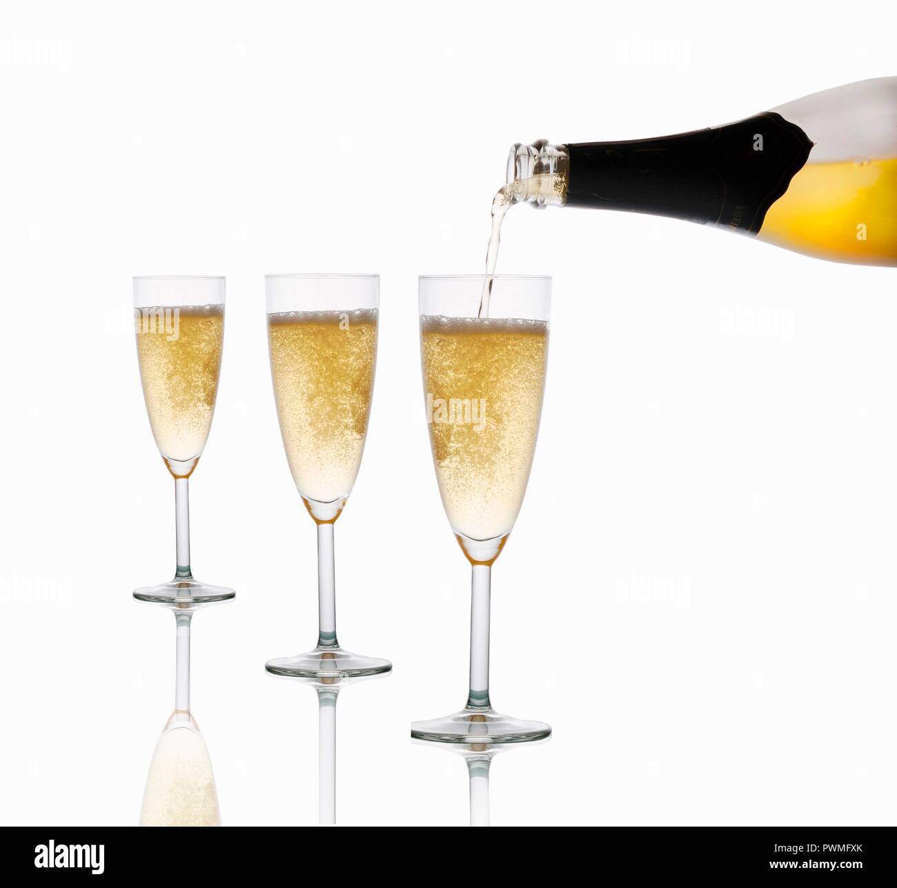 Sparkling wine being poured into glasses Stock Photo - Alamy