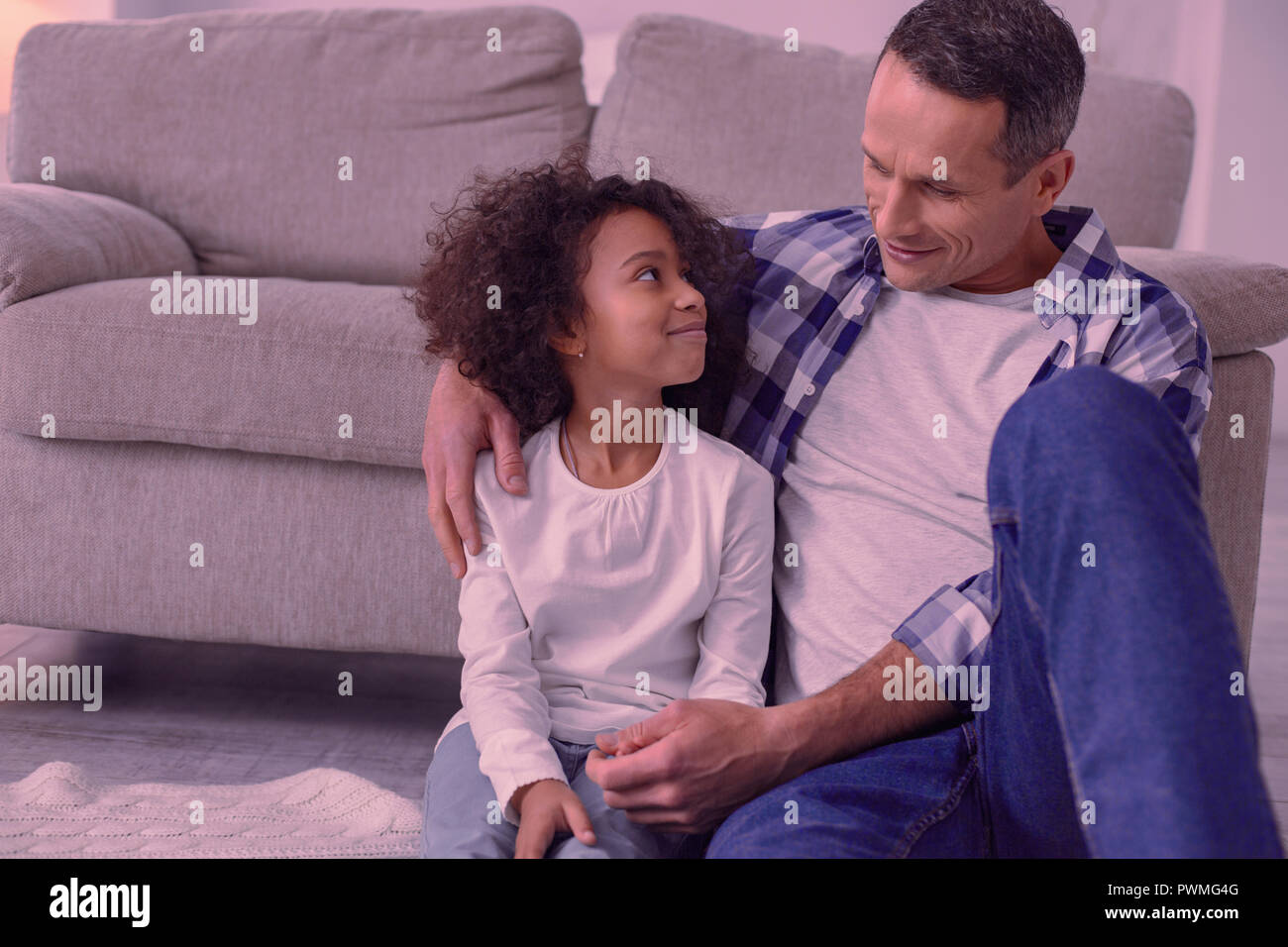 Positive nice man hugging his beloved daughter Stock Photo - Alamy