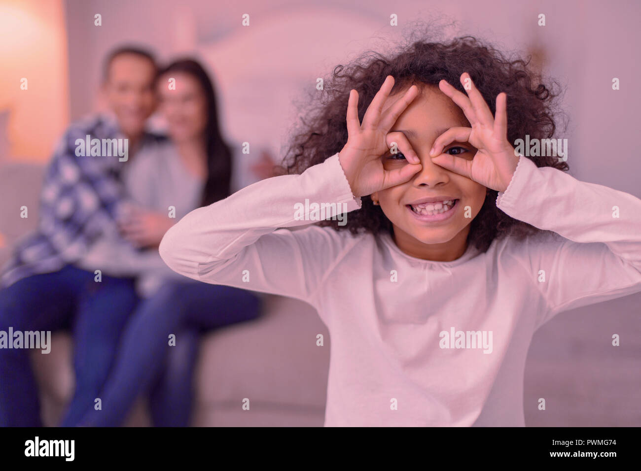 Positive nice curly girl looking at you Stock Photo - Alamy