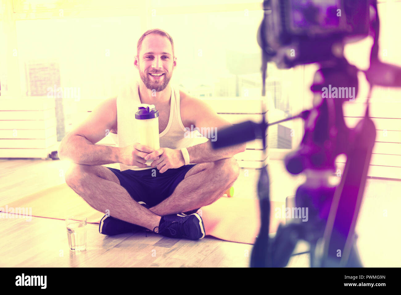Strong smiling man sitting in front of the camera Stock Photo - Alamy