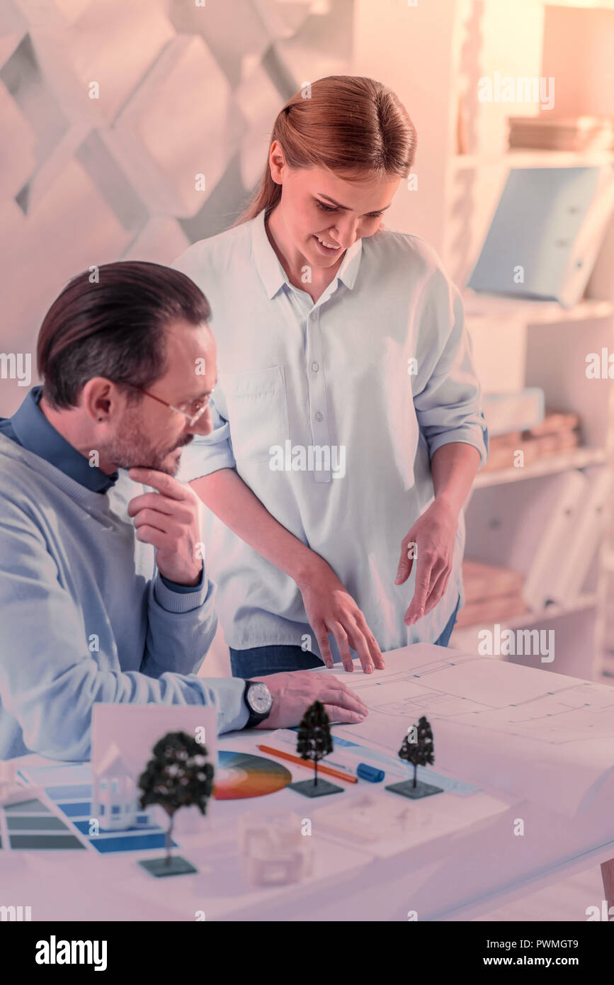 Concentrated designer creating sketch of convenient house Stock Photo ...