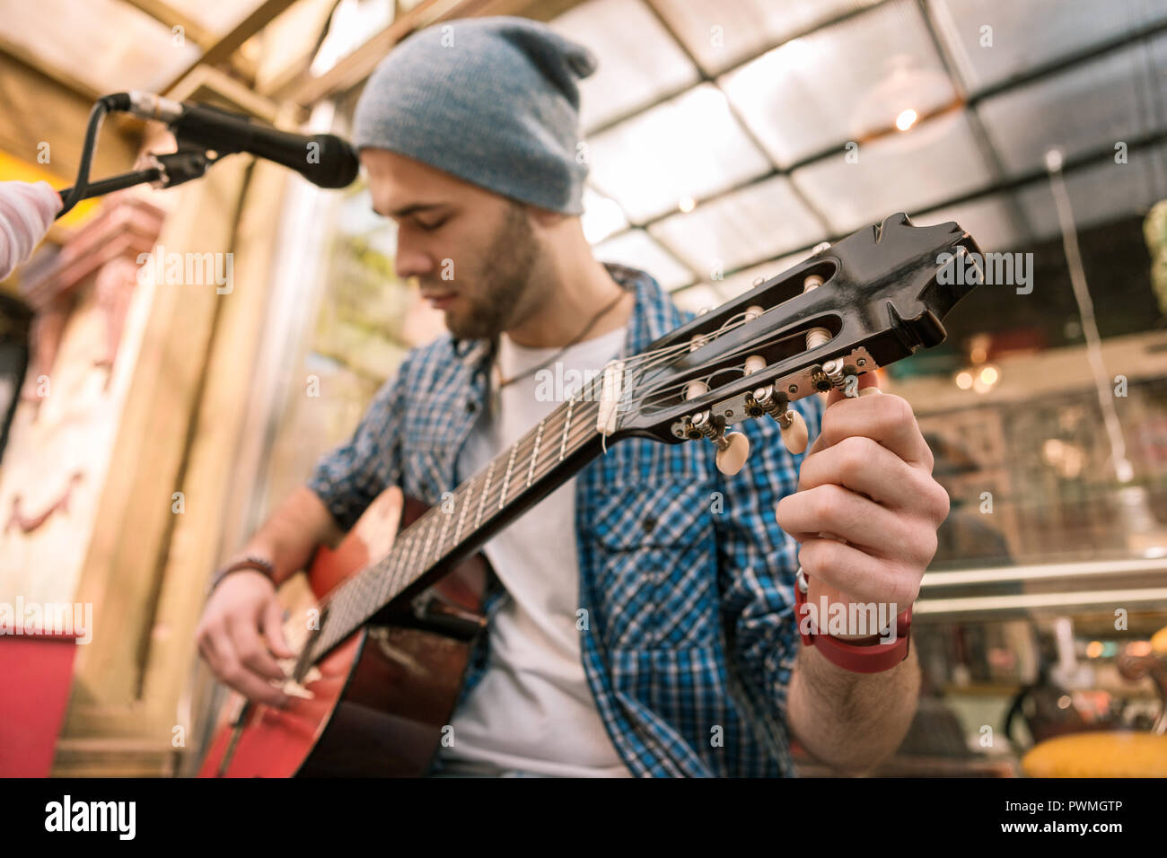Concentrated male guitarist getting ready for performance Stock Photo ...