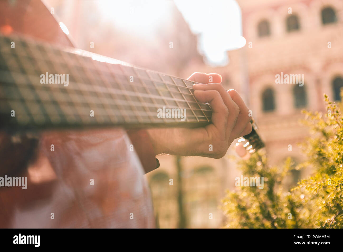 Male handsome hands holding string against frets Stock Photo - Alamy