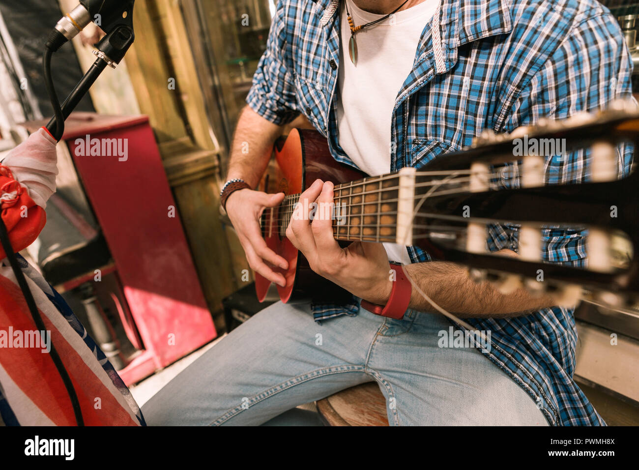 Male handsome guitarist mastering play on guitar Stock Photo - Alamy