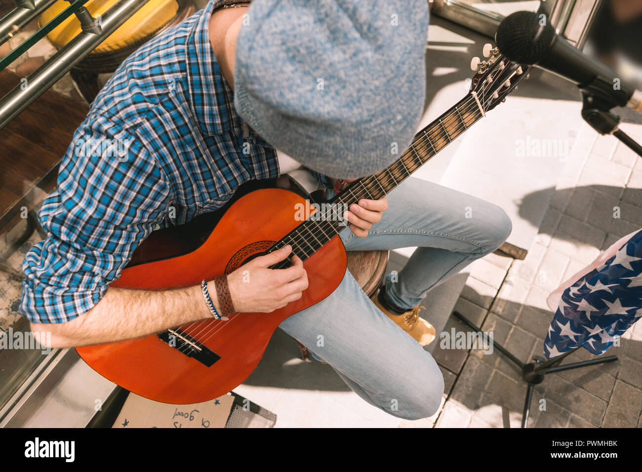 Attractive male guitarist learning chords on street Stock Photo - Alamy