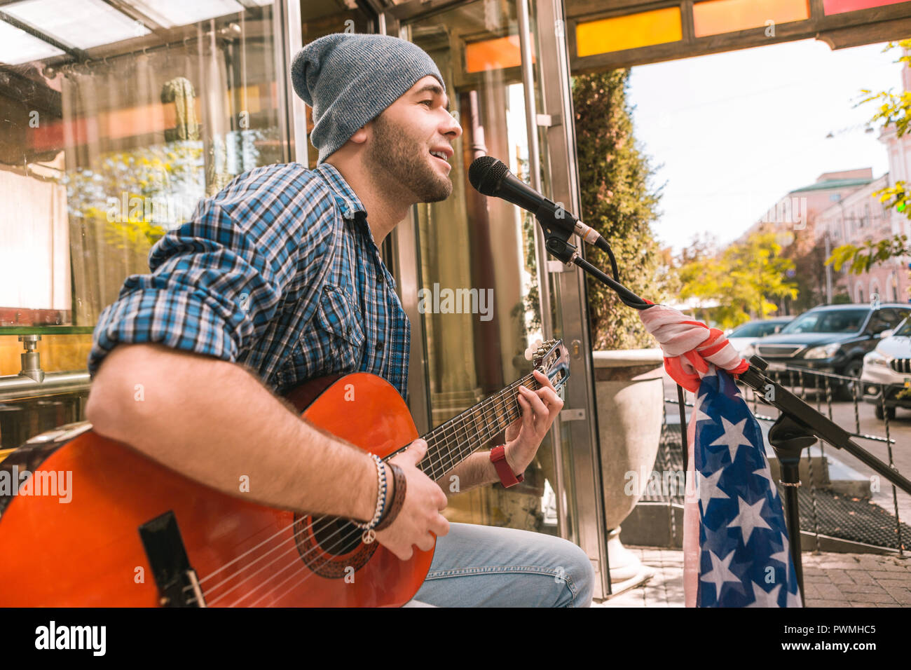 Serious male guitarist freeing emotions through singing Stock Photo - Alamy