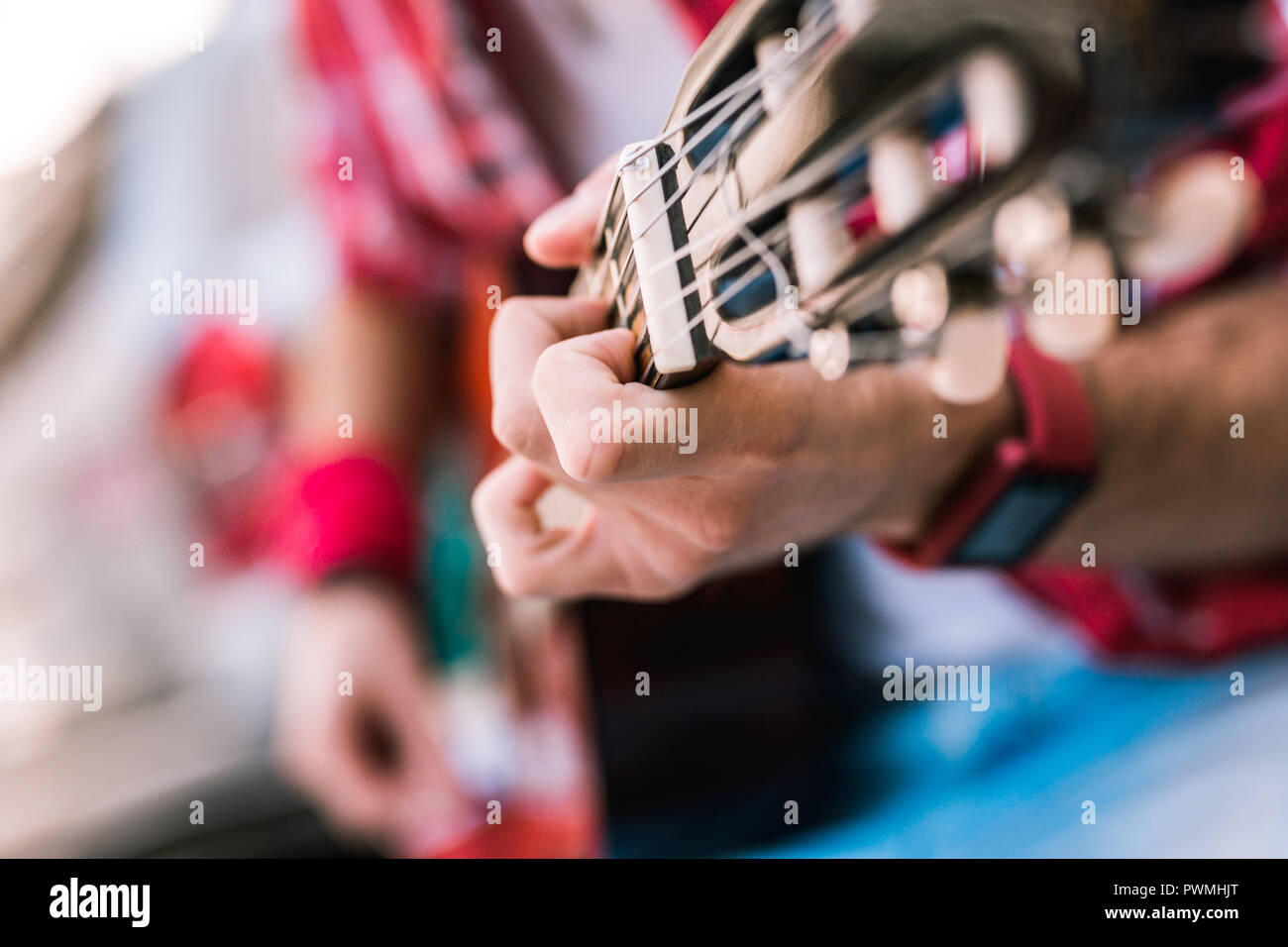 Vigorous male guitarist demonstrating easy guitar chord Stock Photo - Alamy