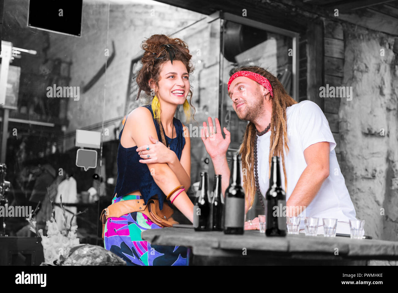Couple of hippies having rest while chilling and laughing in their ...