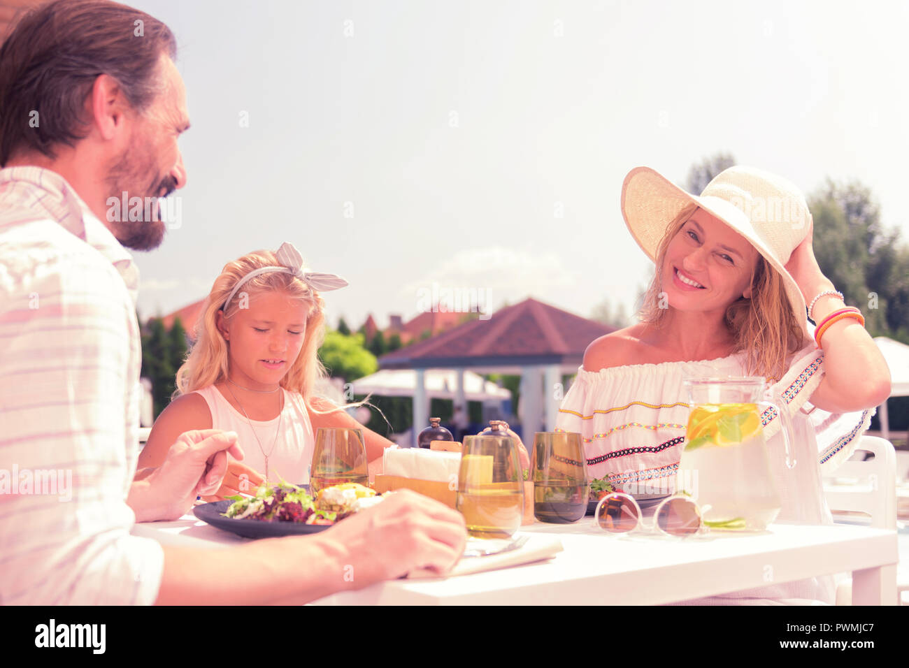 Nice pleasant united family having lunch together Stock Photo - Alamy
